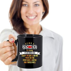 Clinical Nurse Specialist Coffee Mug. Being A Clinical Nurse Specialist Is Easy Like Riding A Bike Except The Bike Is On Fire You're On Fire And In Hell Funny Gifts for Women Men 11 oz black