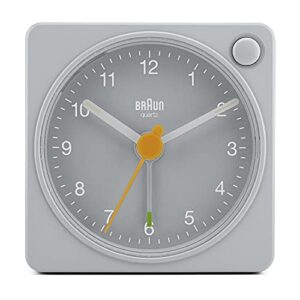 braun classic travel analogue alarm clock with snooze and light, compact size, quiet quartz movement, crescendo beep alarm in grey, model bc02xg