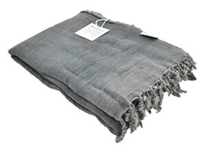 stonewashed turkish throw blanket in charcoal grey/faded black, soft, cozy and lightweight, perfect for use as a love seat or sofa throw, partical bed cover, beach blanket or yoga blanket