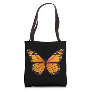 monarch butterfly black background tote bag