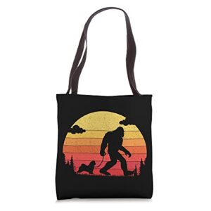 retro bigfoot silhouette walking maltese dog tote bag