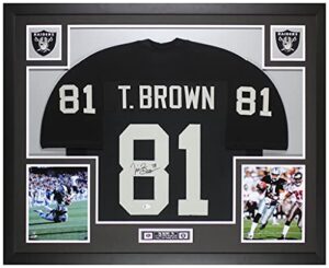 tim brown autographed black oakland jersey – beautifully matted and framed – hand signed by brown and certified authentic by beckett – includes certificate of authenticity