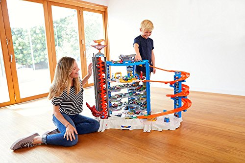 Hot Wheels Toy Car Track Set & 4 1:64 Scale Cars, Super Ultimate Garage, 3+ Ft Tall with Motorized Gorilla & Storage for 140 Cars