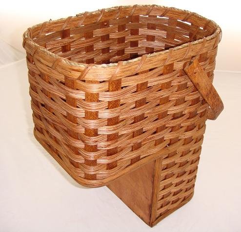 Large 9" stair step basket. Beautifully rests on your stairsteps. Swivel handle, all natural material and made by Old Order Amish. The up splints that are used are on these baskets are oak. Perfect for storing books and magazines. Colors may vary.