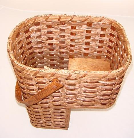 Large 9" stair step basket. Beautifully rests on your stairsteps. Swivel handle, all natural material and made by Old Order Amish. The up splints that are used are on these baskets are oak. Perfect for storing books and magazines. Colors may vary.