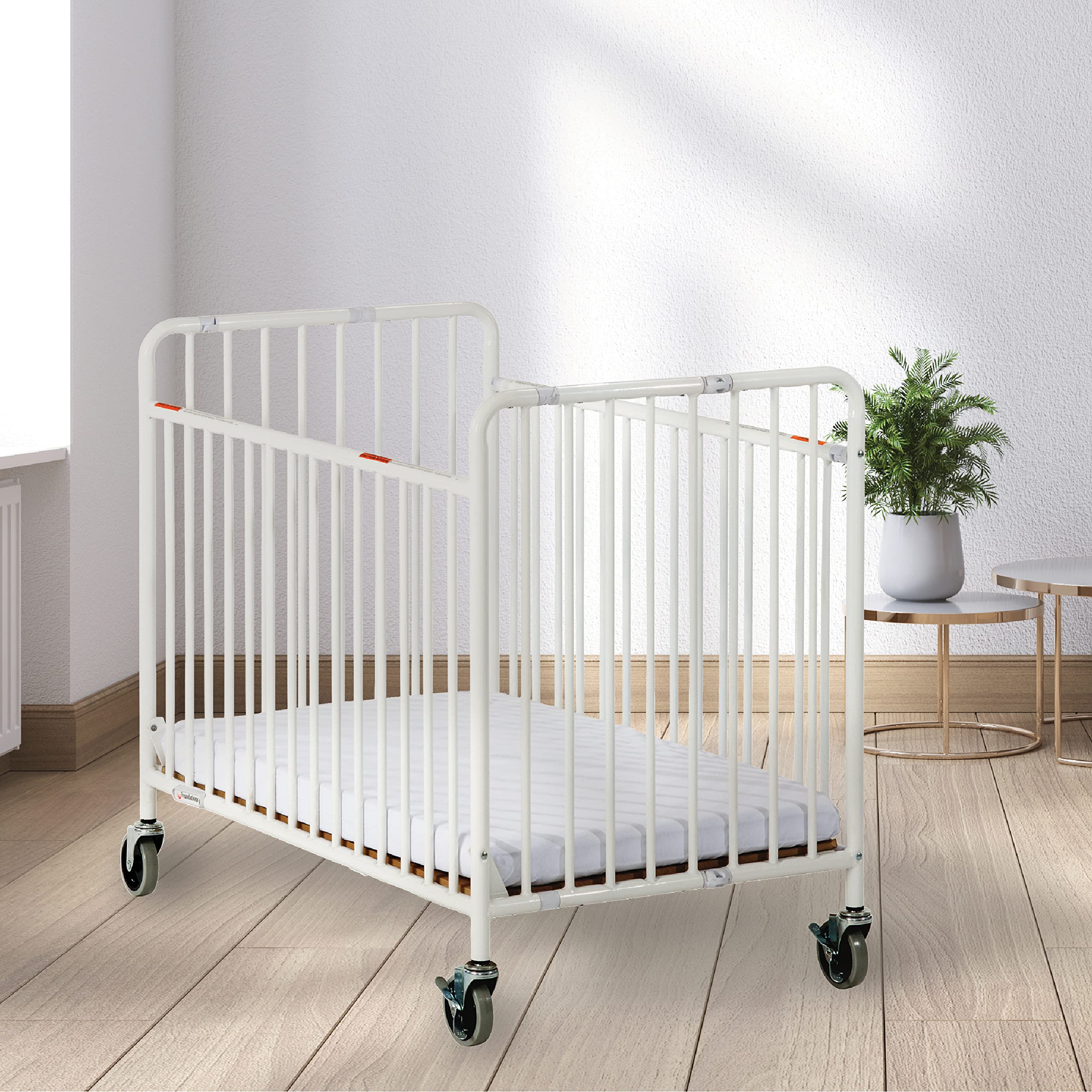 Foundations Stowaway Metal Folding Crib, Portable Baby Crib with Foam Mattress and Commercial Grade 3" Casters, Compact Traveling Crib (White Steel)