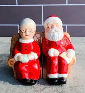 ebros gift north pole residence mr and mrs santa claus sitting on sofa chair christmas couple salt and pepper shakers set ceramic figurines party kitchen tabletop collectible