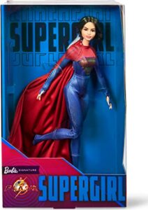 supergirl barbie doll, collectible doll from the flash movie wearing red and blue suit with cape, doll stand included