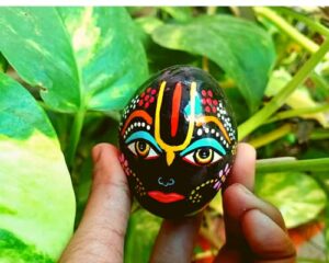 decorated stone krishna laddu gopal ji painted black stone shaligram shaligram shila religious gifts ritual object for home temple and gifting decorative showpiece