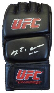 anderson silva autographed ufc fight glove w/proof, picture of anderson signing for us. ufc middleweight champion, brazil, chael sonnen, dana white, chris weidman