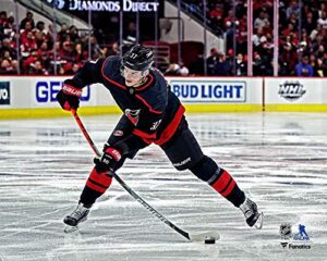 andrei svechnikov carolina hurricanes unsigned black alternate jersey shooting photograph - original nhl art and prints