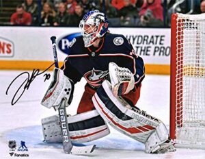 joonas korpisalo columbus blue jackets autographed 8" x 10" blue jersey in net photograph - autographed nhl photos