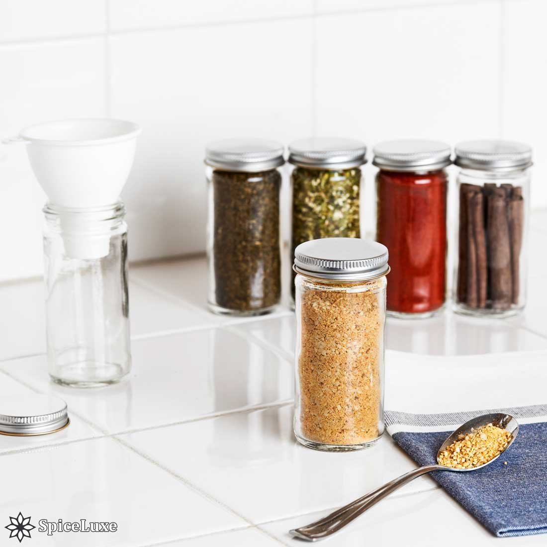 SpiceLuxe 12 Premium Round Glass Spice Bottles, Premium Jars with Silver Metal Lids, Shaker Tops, and Blank Labels