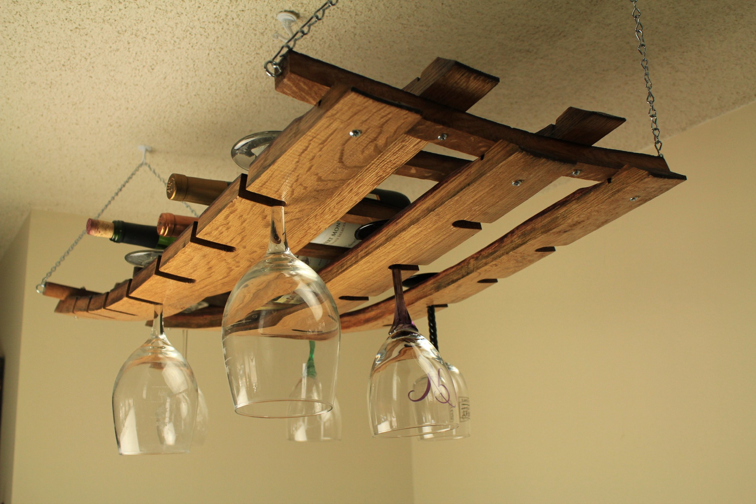 Hanging wine bottle and glass rack made from oak wine barrel staves