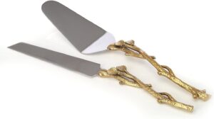 le'raze 2 piece gold-leaf (twig) cake server set. 1 cake knife and 1 cake server. leaf design 2 tone made of stainless steel and brass. ideal for weddings, parties, elegant events