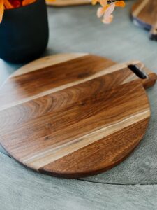 round charcuterie serving board with handle, handmade in the usa with walnut hardwood.