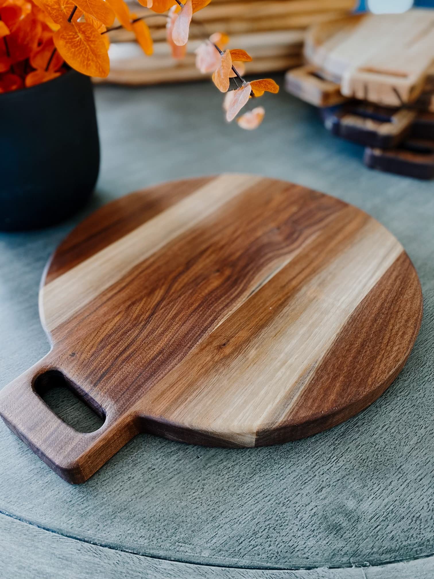 Round charcuterie serving board with handle, handmade in the USA with Walnut hardwood.