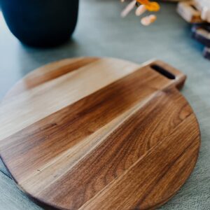 Round charcuterie serving board with handle, handmade in the USA with Walnut hardwood.