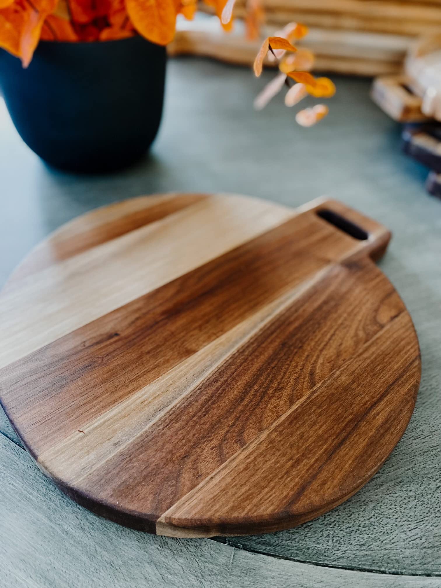 Round charcuterie serving board with handle, handmade in the USA with Walnut hardwood.