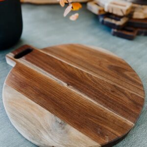 Round charcuterie serving board with handle, handmade in the USA with Walnut hardwood.