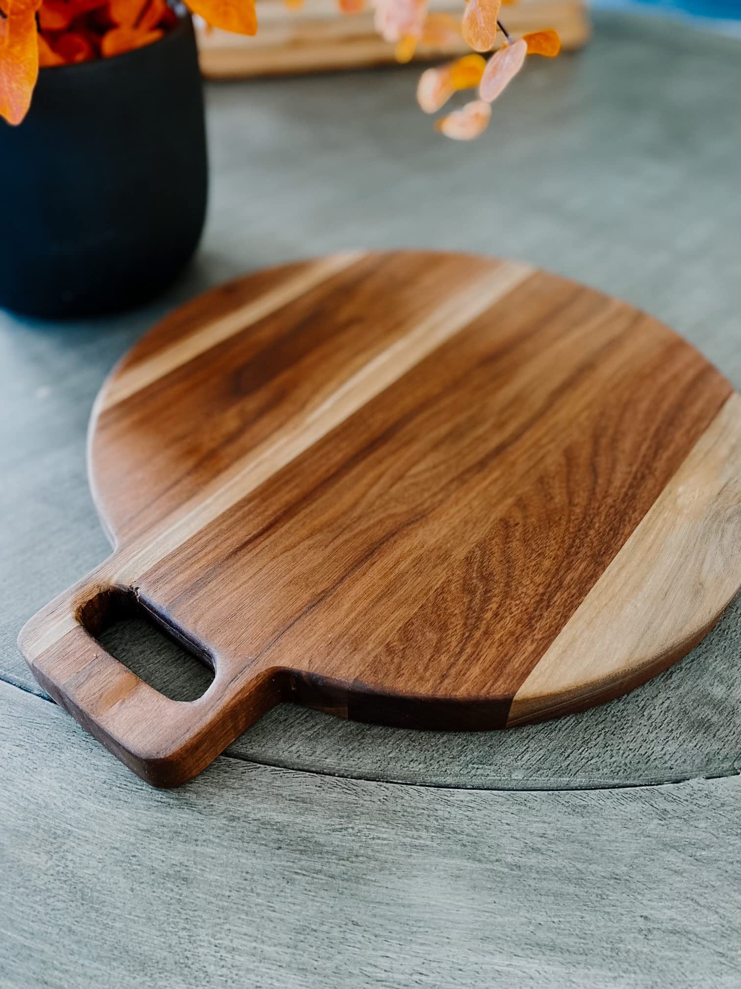 Round charcuterie serving board with handle, handmade in the USA with Walnut hardwood.