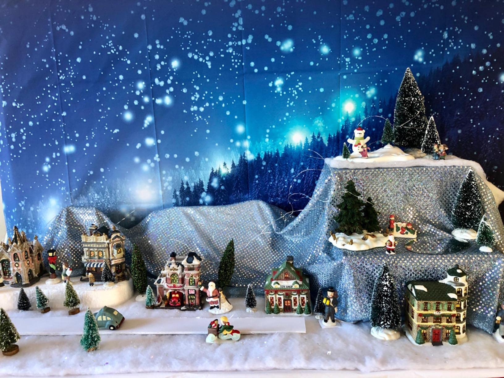 Leowefowa 7X5FT Christmas Backdrop Rustic Village Night View Forest Trees Snowing Shining Lights Blue Sky Winter Xmas Vinyl Photography Background Kids Children Adults Photo Studio Props