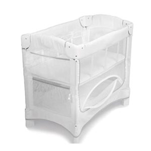 arm’s reach mini ezee 2 in 1 co-sleeper bedside bassinet featuring breathable mesh side panels with 2 wheels for portability, side pockets, and bottom storage, white