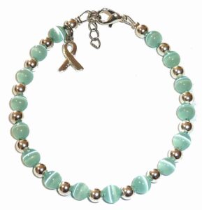 cancer awareness bracelet, for showing support or fundraising campaign, adult size with extension, 6mm cat's eye beads. comes packaged. (ovarian cancer - teal)