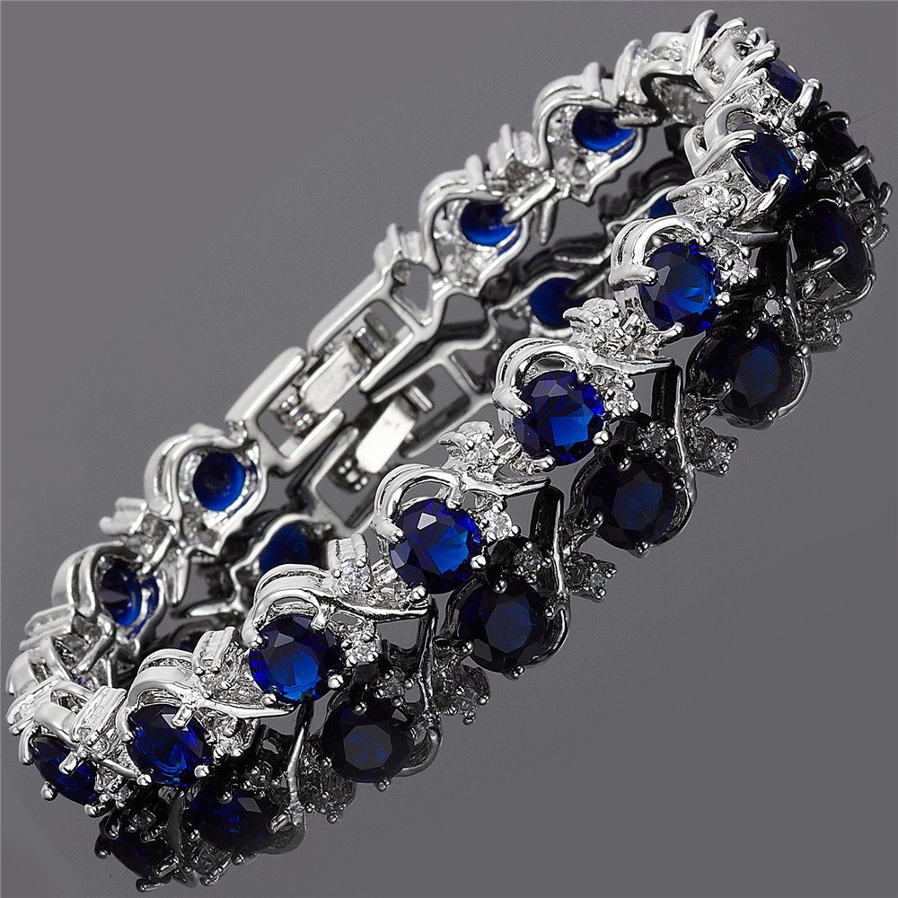 RIZILIA Blossom Round Simulated Blue Sapphire and White Cubic Zirconia 18K White Gold Plated Tennis Bracelet, 7"