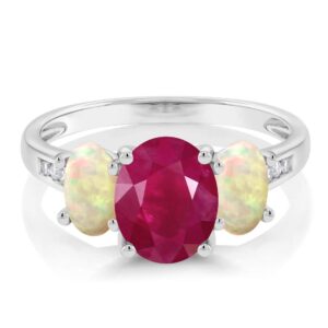 Gem Stone King 10K White Gold Red Ruby White Ethiopian Opal and White Diamond Oval 3-Stone Engagement Ring For Women (2.24 Cttw, Gemstone July Birthstone, Available In Size 5, 6, 7, 8, 9)