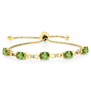 gem stone king 18k yellow gold plated silver green peridot and white lab grown diamond tennis bracelet for women (4.52 cttw, gemstone august birthstone, oval 7x5mm, fully adjustable up to 9 inch)