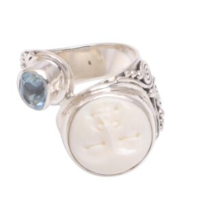 NOVICA Artisan Handmade Blue Topaz Cocktail Ring Bone Face from Bali Sterling Silver Indonesia Birthstone Gemstone [ring Front 0.6 in L x 0.6 in W x 0.3 in H Band Width 7 mm W] ' Sparkling Face'