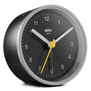 braun classic analogue alarm clock with snooze and light, quiet quartz movement, crescendo beep alarm in black and silver, model bc12sb.