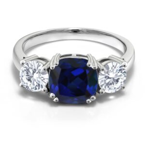 925 sterling silver blue created sapphire and forever classic moissanite from charles & colvard 3 stone engagement ring for women (3.50 cttw, gemstone september birthstone, cushion 8mm, size 5)