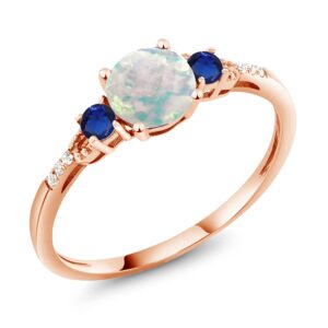 gem stone king 10k rose gold white simulated opal blue created sapphire and white diamond accent 3-stone engagement ring for women (0.95 cttw, round cabochon 6mm, gemstone october birthstone, size 9)