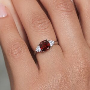 Gem Stone King 10K White Gold Red Garnet and White Created Sapphire 3-Stone Engagement Ring For Women (2.49 Cttw, 7MM Cushion and 4MM Trillion, Available In Size 5, 6, 7, 8, 9)