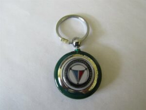 valiant logo emblem round plastic keychain - green