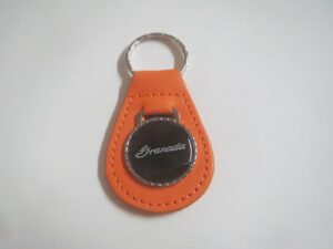 1975 1976 1977 1978 1979 1980 1981 1982 granada script logo leather keychain - pumpkin