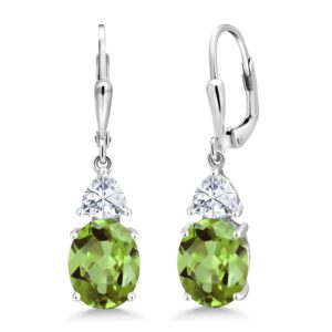 gem stone king 925 sterling silver green peridot and white moissanite dangle earrings for women (6.54 cttw, gemstone august birthstone, oval 10x8mm, trillion 5mm)