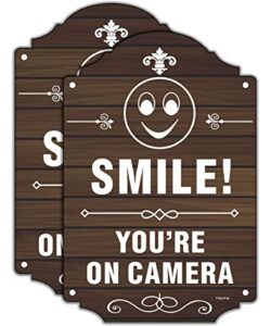 2 pack smile you're on camera signs video surveillance signs 12 x 8 inches home business driveway alert cctv security camera warning signs metal reflective rust aluminum indoor or outdoor use