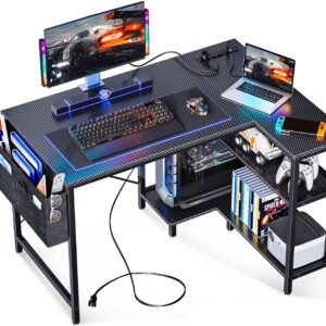 ODK 40 Inch Small L Shaped Gaming Computer Desk with Power Outlets, Corner Desk with Reversible Storage Shelves & PC Stand for Small Space, Modern Simple Home Office Table, Carbon Fiber Surface, Black