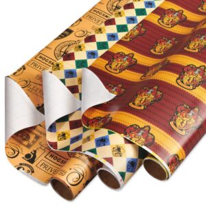 american greetings 105 sq. ft. harry potter wrapping paper set with gridlines for birthdays, graduations and all occasions, hogwarts house crests, gryffindor robe and marauders map (3 rolls, 30 in. x 14 ft. each)