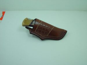 buck 110 folding pocket knife sheath. the sheath is made out of 9 ounce leather. . the sheath is died light brown with a basket weave tooling. this i for sheath only knife not included.