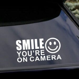 (2 Pack) 7"x3.5" White - Smile You're On Camera - UV Resistant, Waterproof, Peel & Stick Decor Decal Sticker Quote Adhesive Vinyl Mural Art Script Lettering - For storefronts, cars, trucks, boats, etc