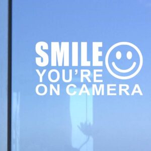 (2 Pack) 7"x3.5" White - Smile You're On Camera - UV Resistant, Waterproof, Peel & Stick Decor Decal Sticker Quote Adhesive Vinyl Mural Art Script Lettering - For storefronts, cars, trucks, boats, etc