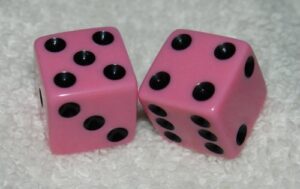 pink with black dots opaque dice pair